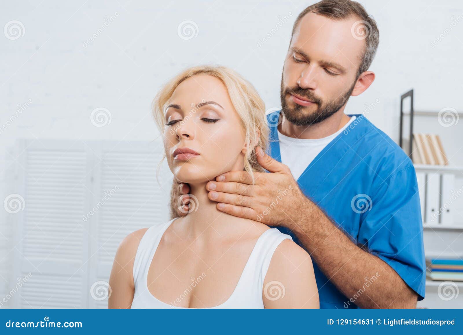 Portrait Of Massage Therapist Massaging Neck Of Young Woman Stock Image