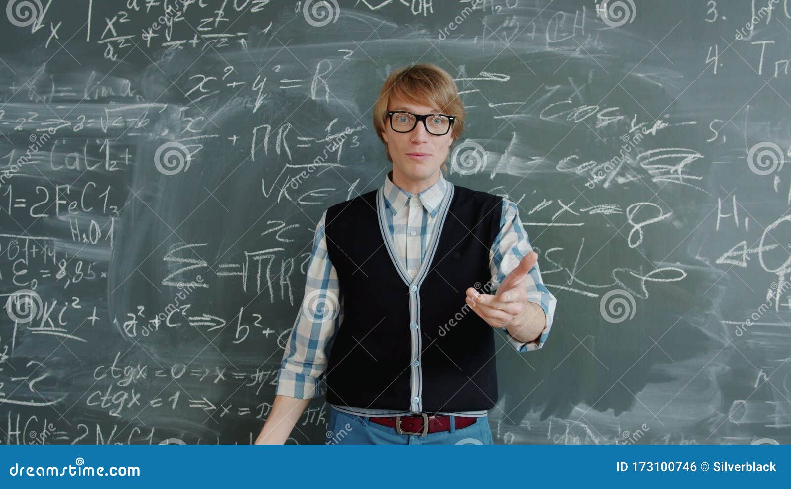 Portrait of Maths Tutor Writing Formulas on Chalkboard Then Looking at ...