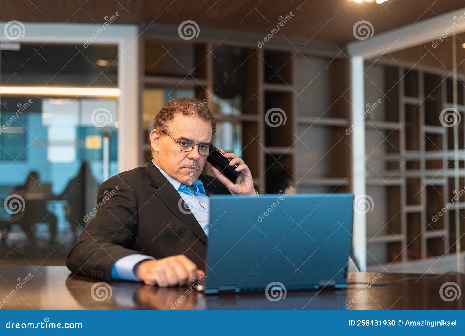 Portrait of Mature Businessman Using Laptop Computer and Mobile Phone ... Portrait of Mature Businessman Using Laptop Computer and Mobile Phone ...