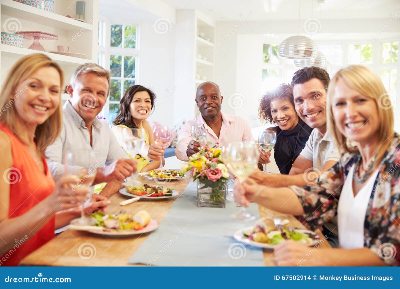 Portrait of Mature Friends Around Table at Dinner Party Stock Photo ...