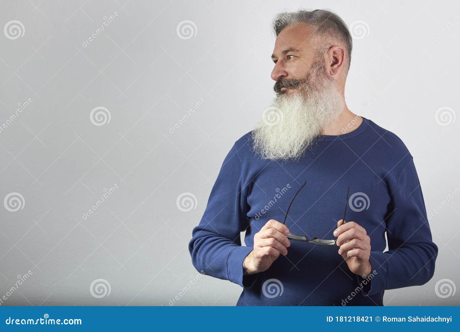 Portrait Of Mature Gray Haired Bearded Man In Blue Sweatshirt With