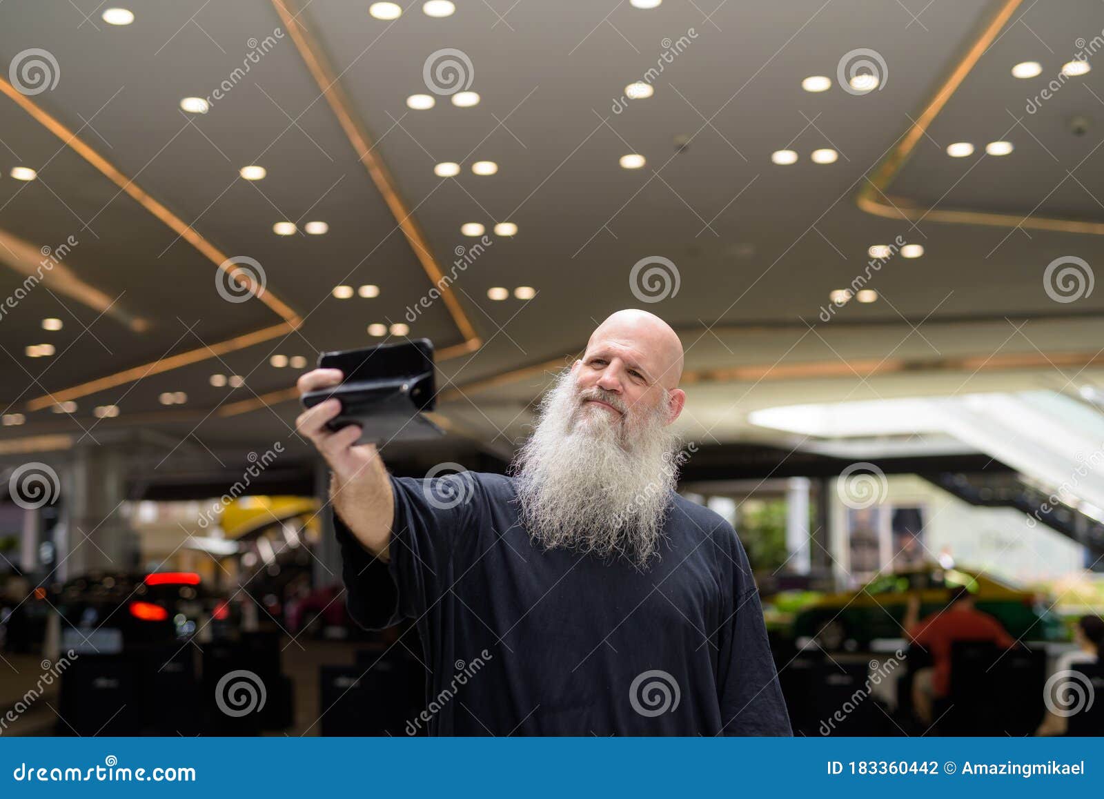 Mature Handsome Bald Bearded Man Taking Selfie in the City Outdoors ... Mature Handsome Bald Bearded Man Taking Selfie in the City Outdoors ...