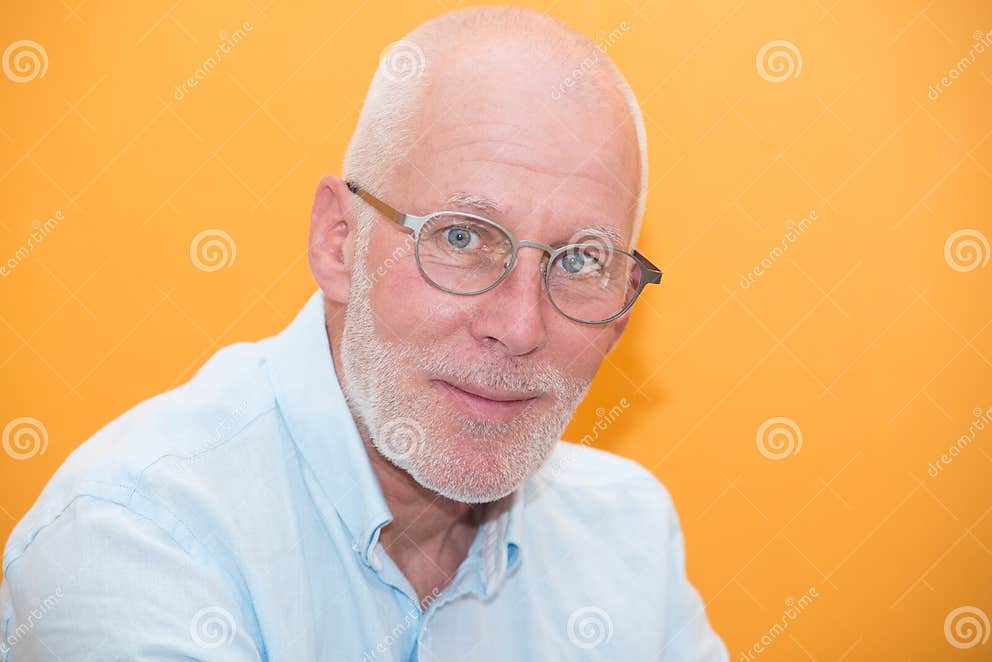 Portrait Of A Mature Man With Glasses Orange Background Stock Image Image Of Happiness