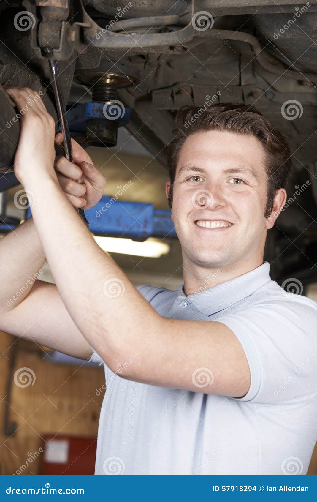 Portrait of Mechanic Working on Wheel Underneath Car Stock Photo ...