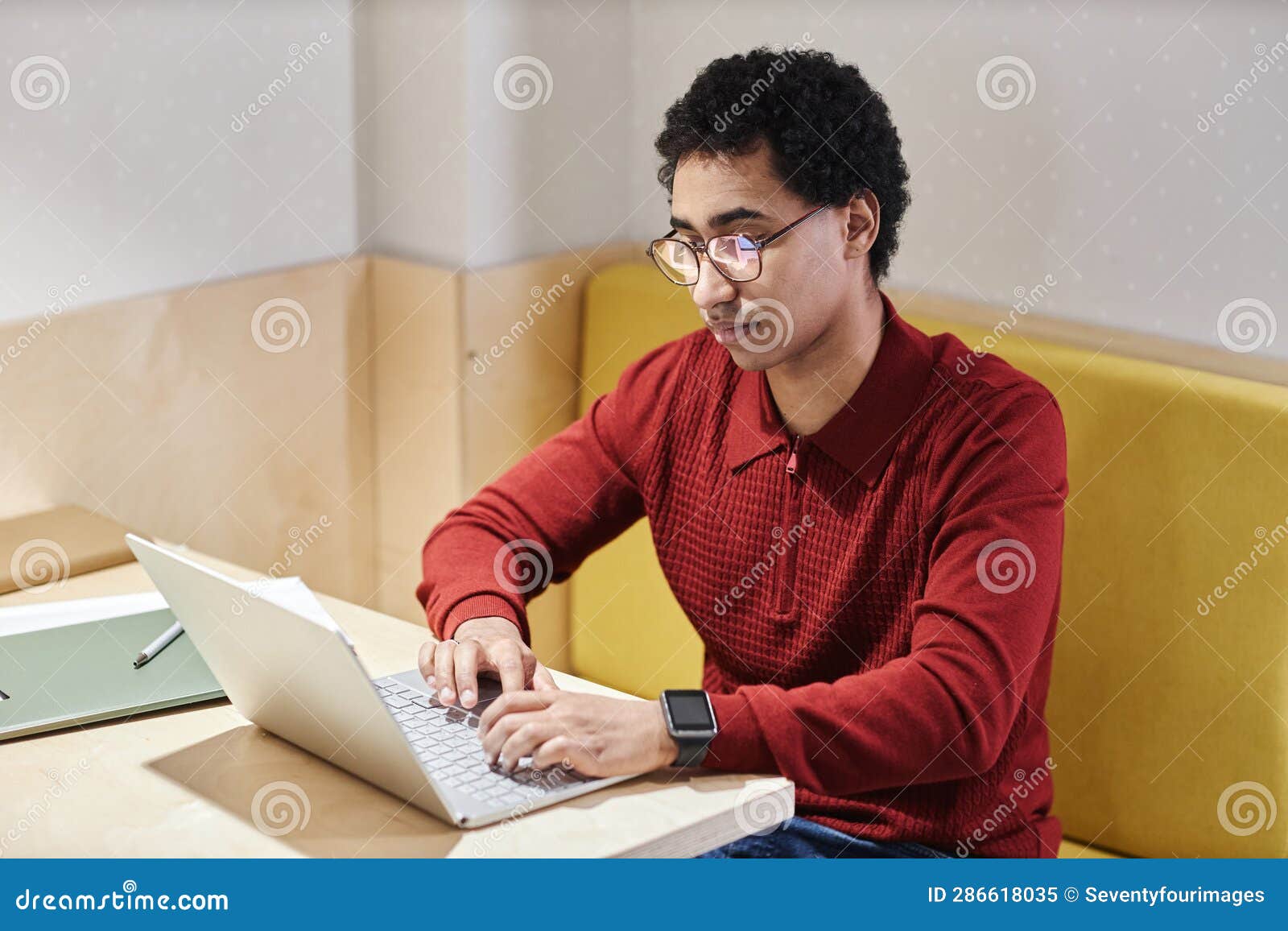 Middle Eastern Young Man Wearing Glasses and Using Computer Stock Image ...