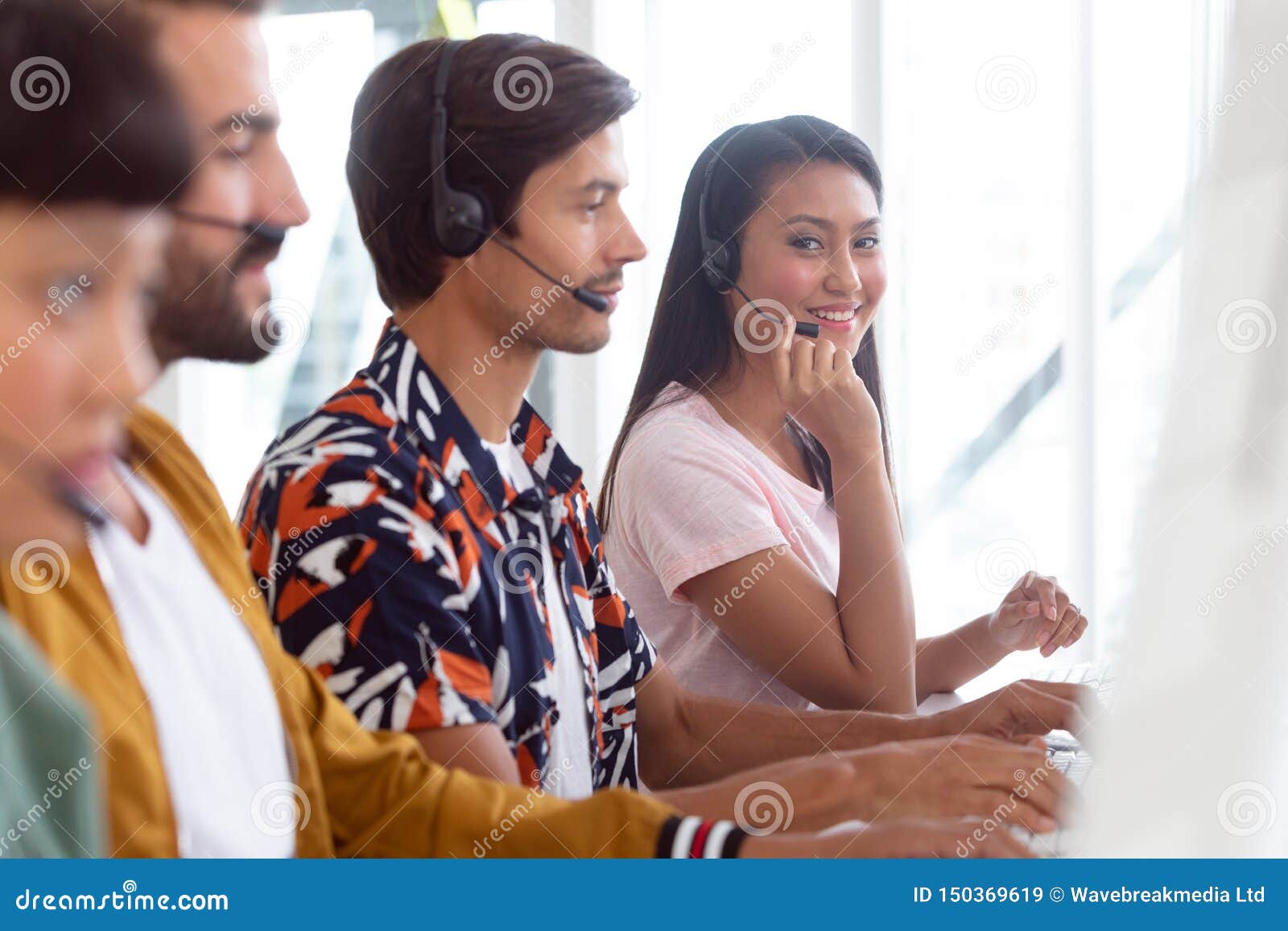 Female Customer Service Executive Working on Computer at Desk in Office ...