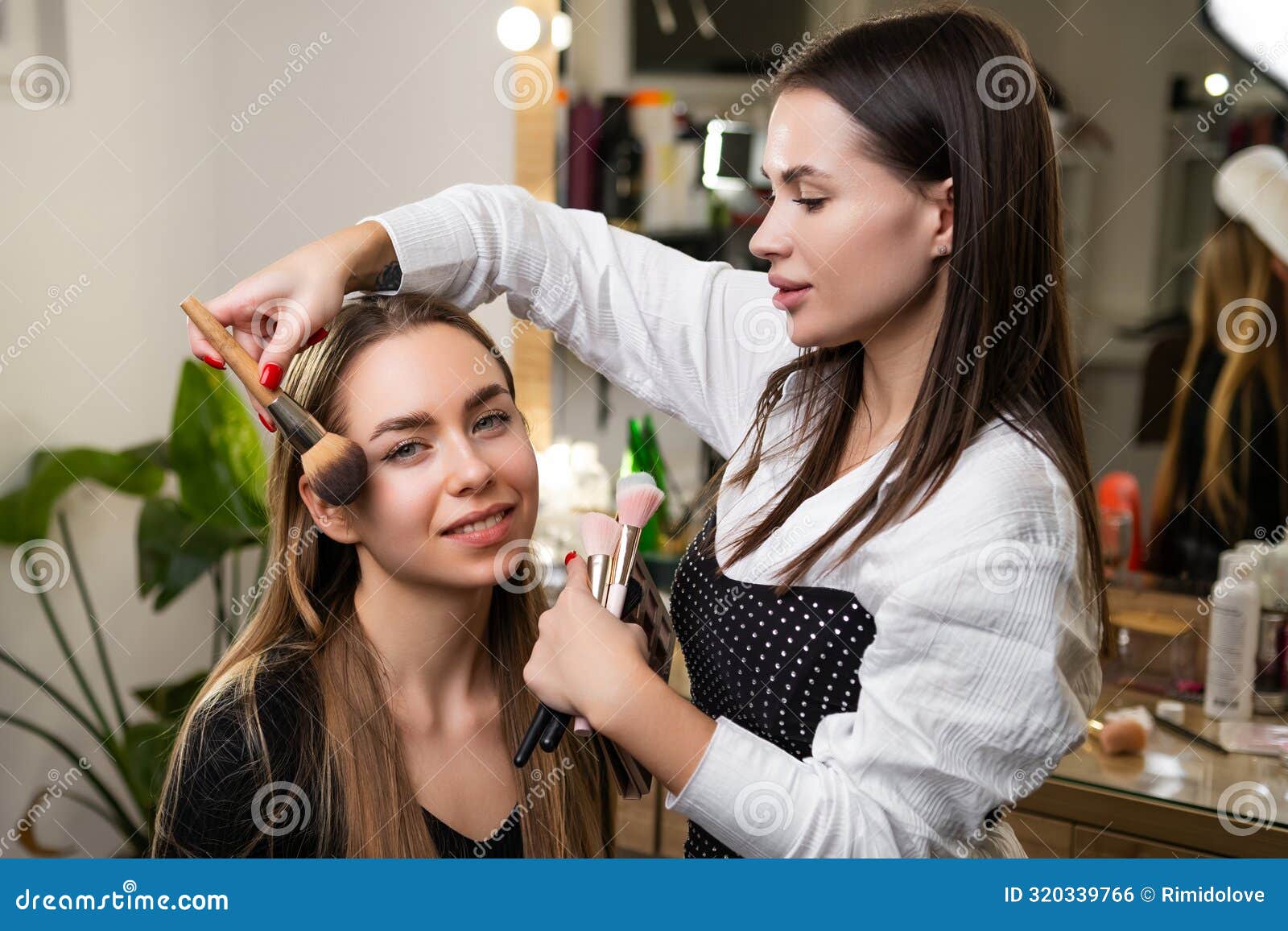 Portrait of Model and Makeup Artist during the Work at Beauty Salon ...