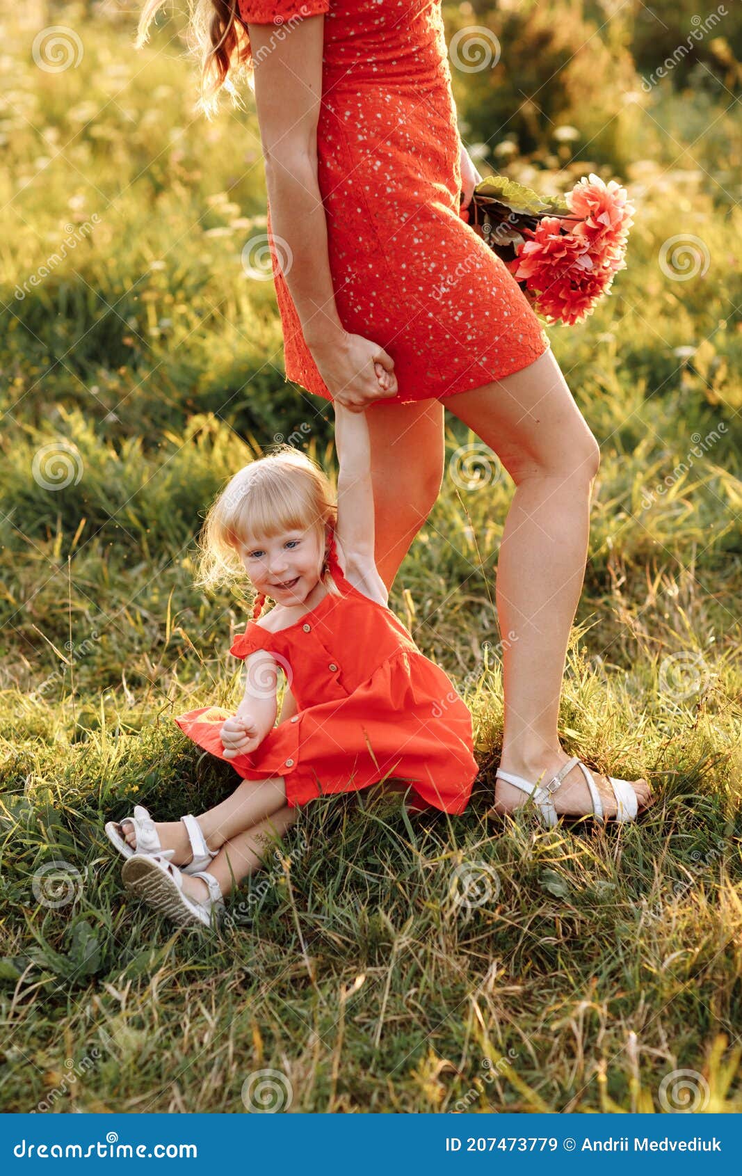 Portrait Of A Mother Holds Throws Up And Spins The Daughter On Hands