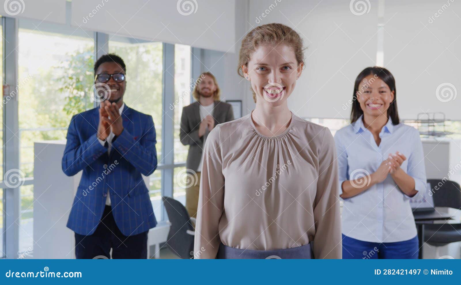 Portrait Of Multi Cultural Business Team Applauding To Young Female