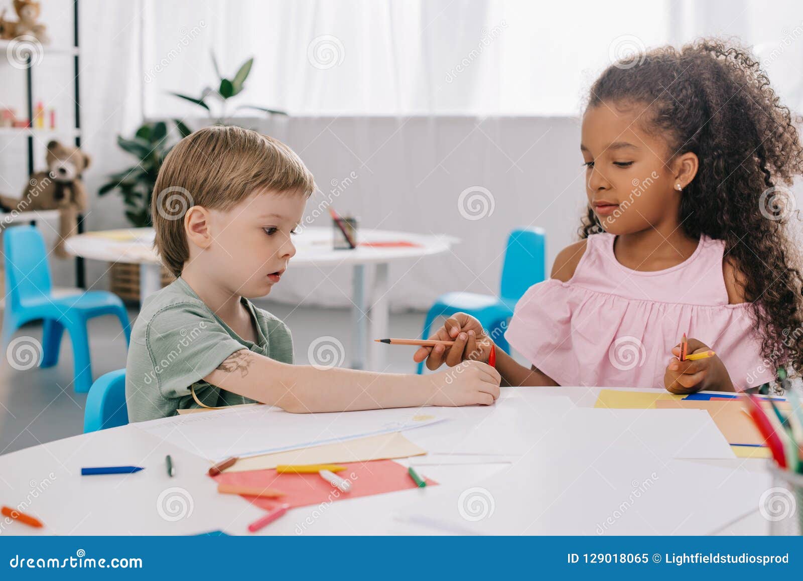 Portrait of Multicultural Preschoolers at Table with Papers and Pencils ...