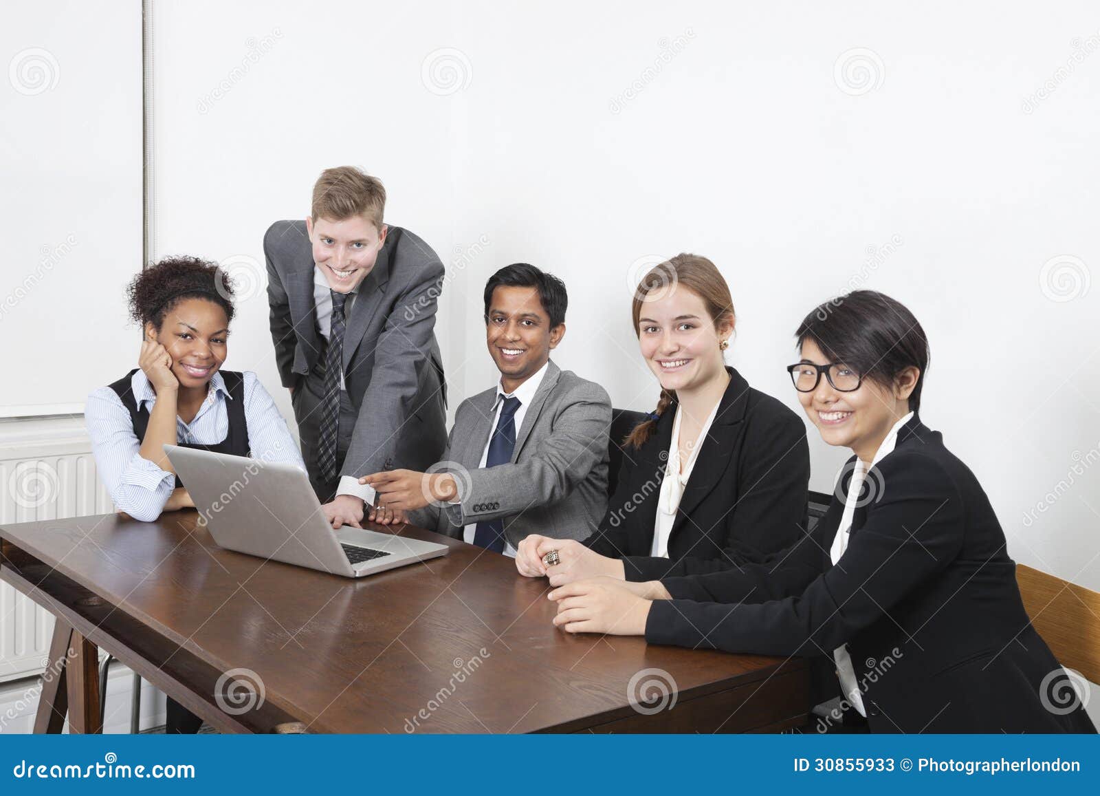 Portrait of Multiethnic Professionals Using Laptop at Conference Room ...