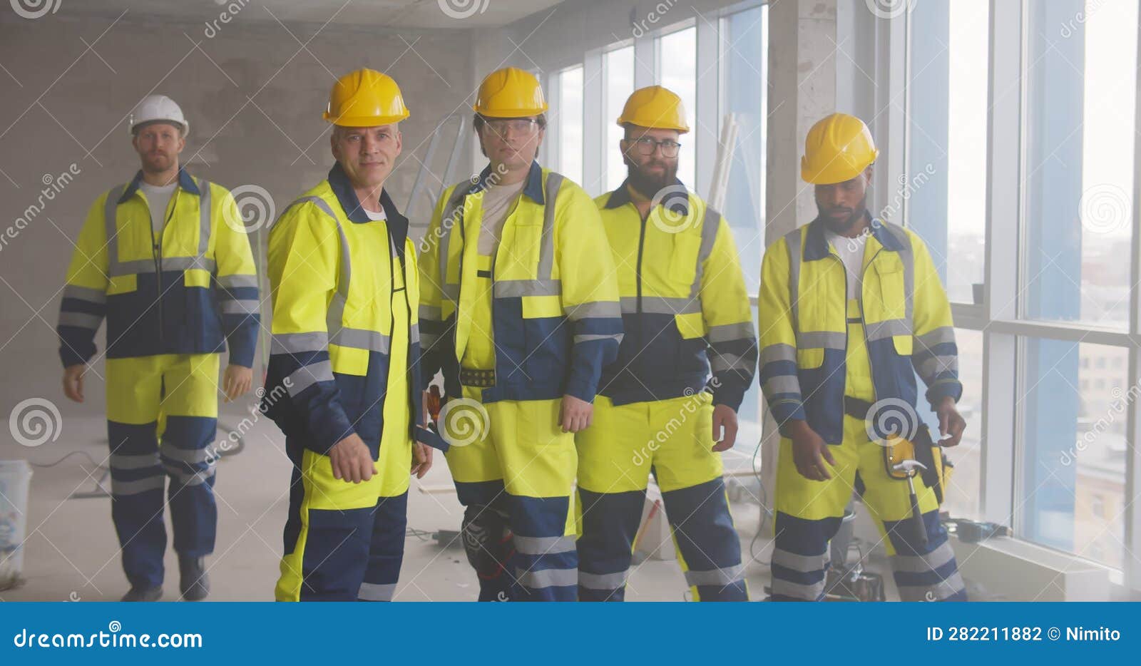 Portrait of Multiethnic Team of Builders in Uniform Posing at Camera on ...