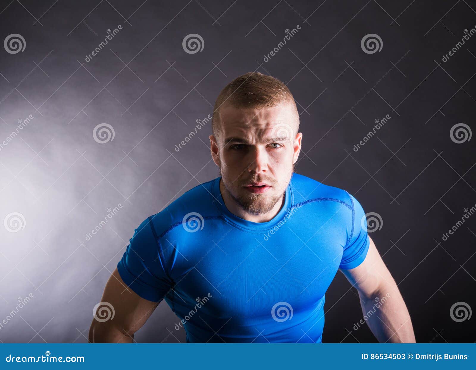 Portrait of a Muscular Aggressive Young Man Standing in Studio on Black ...