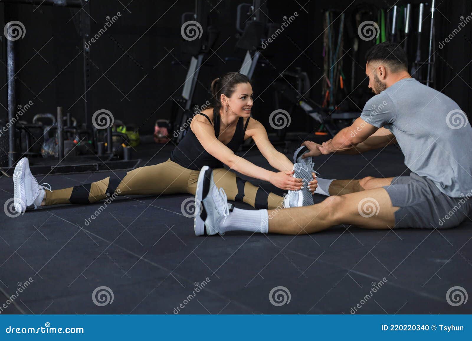 Portrait of a Muscular Couple Doing Leg Stretchings. Stock Photo ...