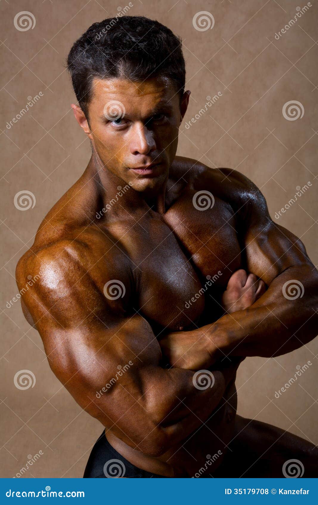 Portrait of a Muscular Man Standing with Folded Hands Stock Photo ...