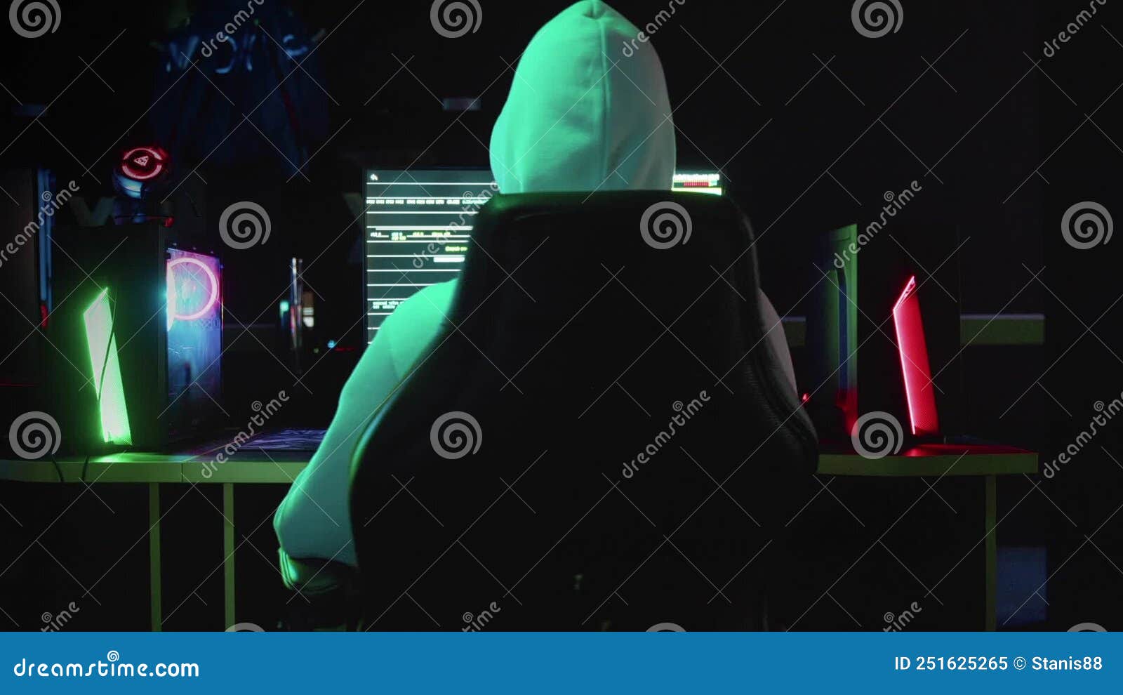 Portrait of a Mysterious Hacker in a Hood, Sitting at a Table and ...