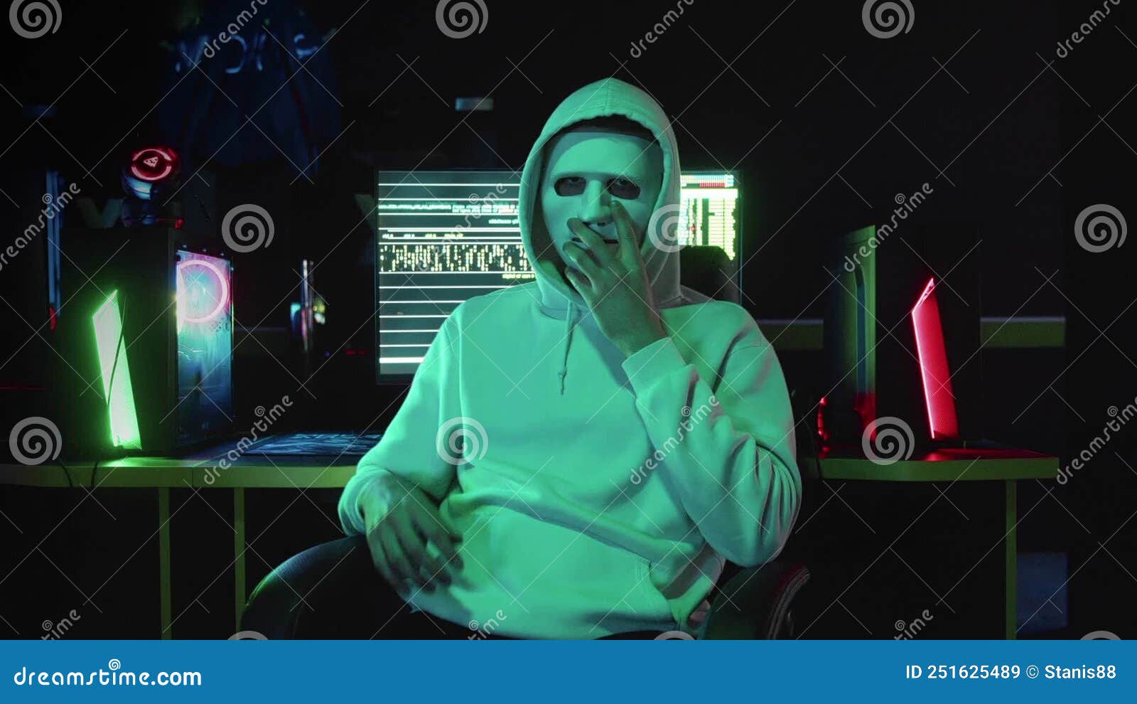 Portrait of a Mysterious Hacker in a Hood, Sitting at a Table and ...