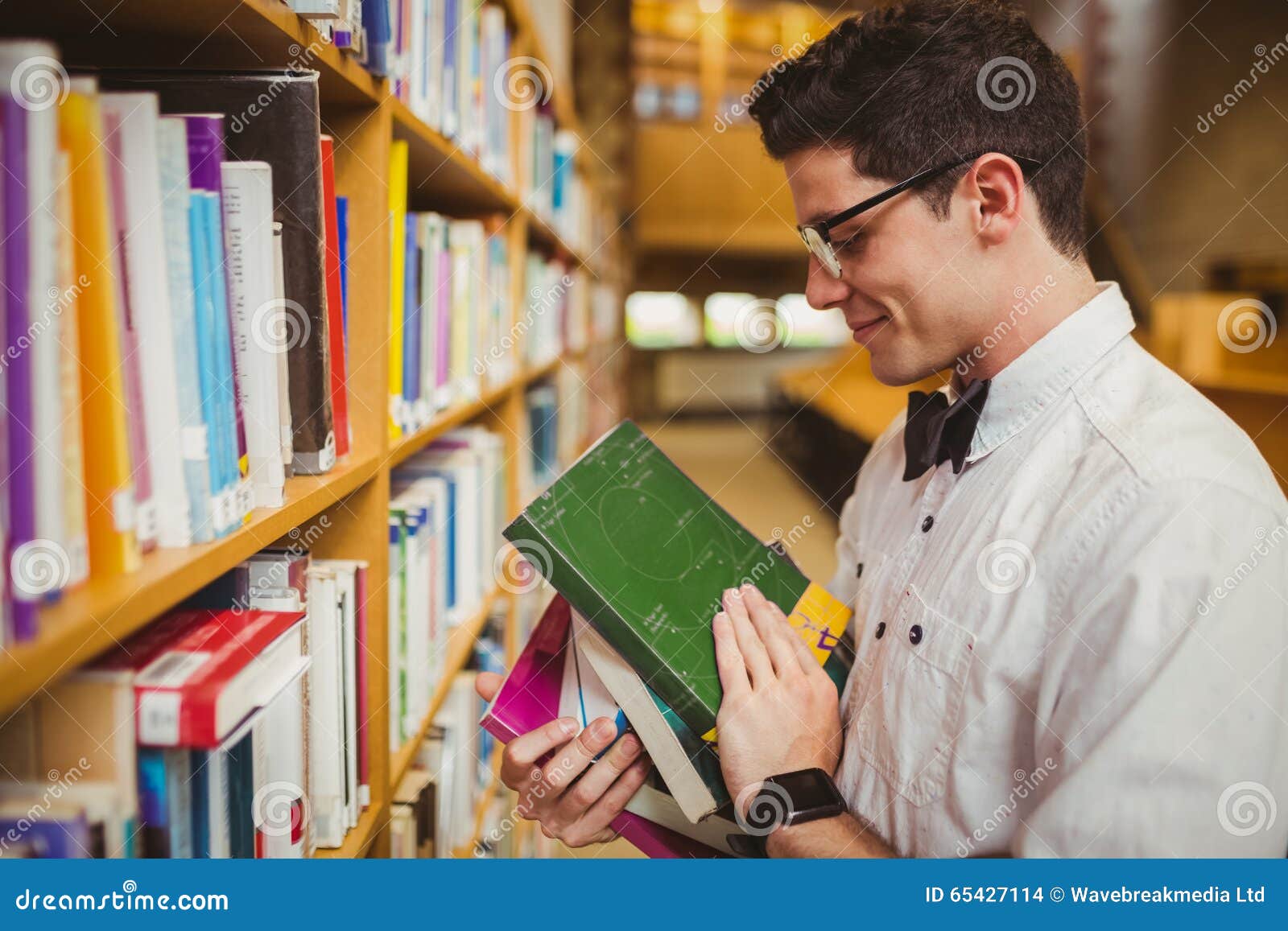 Portrait of Nerd Holding Books Stock Photo - Image of campus, indoors ...