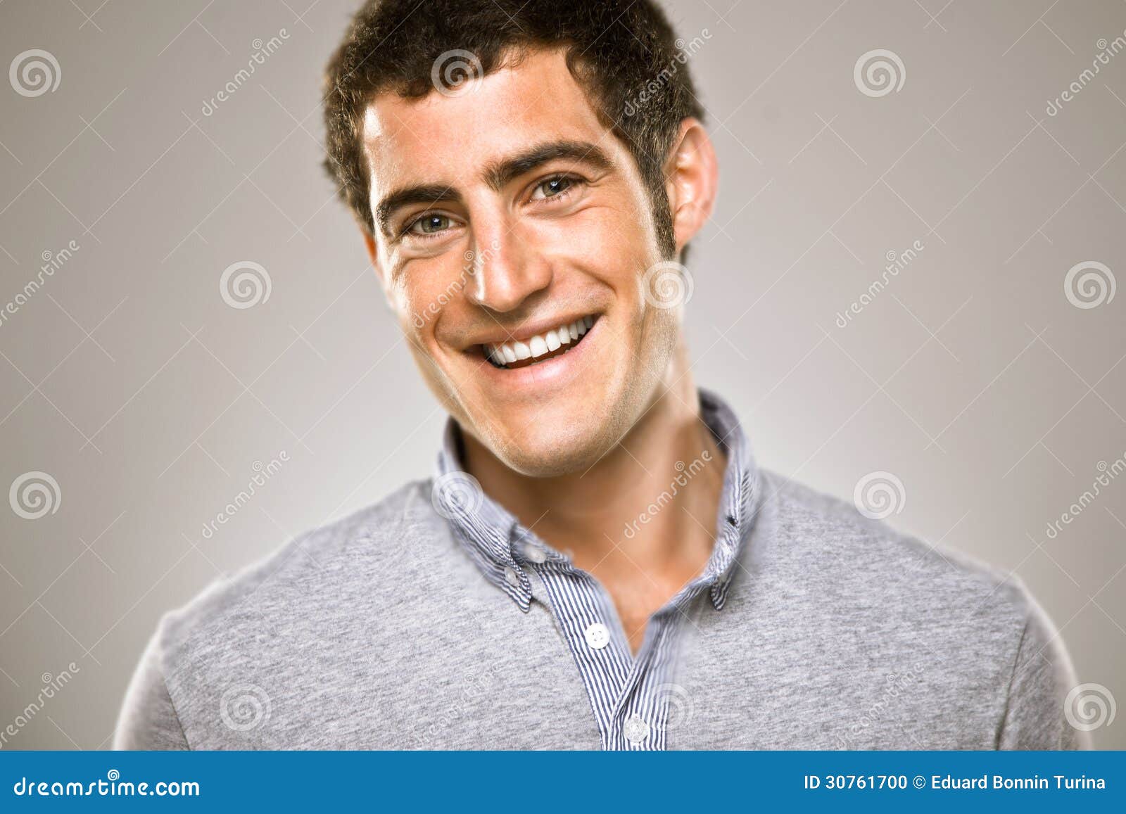 Portrait of a Normal Boy Over Grey Background Sniling. Stock Photo ...