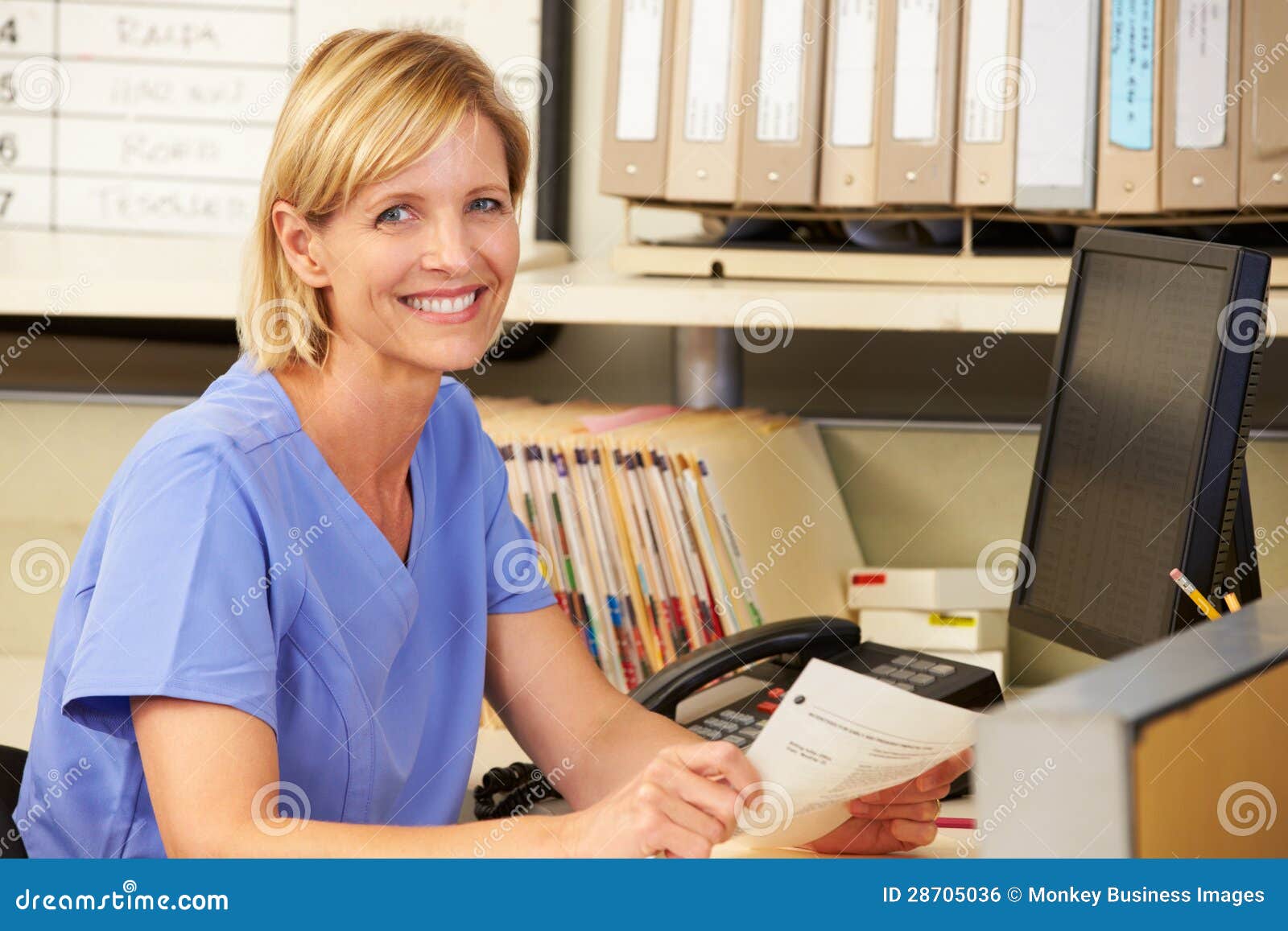 Portrait of Nurse Working at Nurses Station Stock Photo - Image of ...