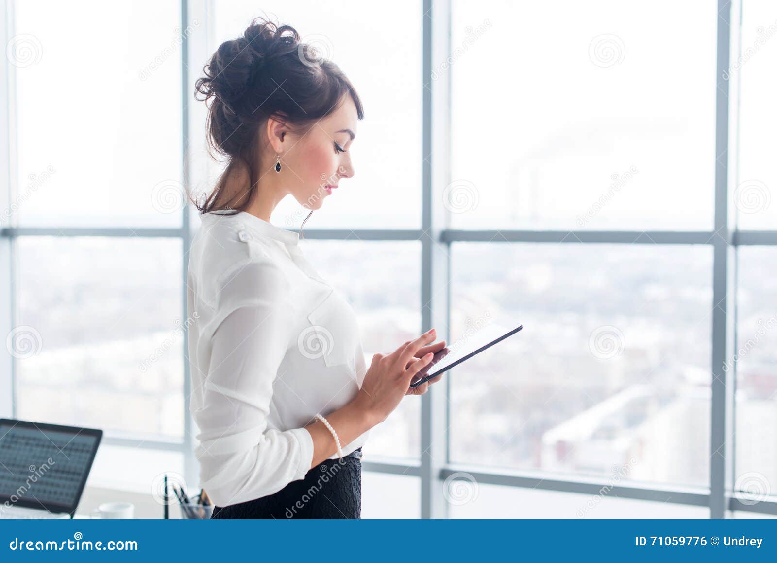 Portrait of an Office Manager Holding Her Tablet, Typing, Using Wi-fi ...