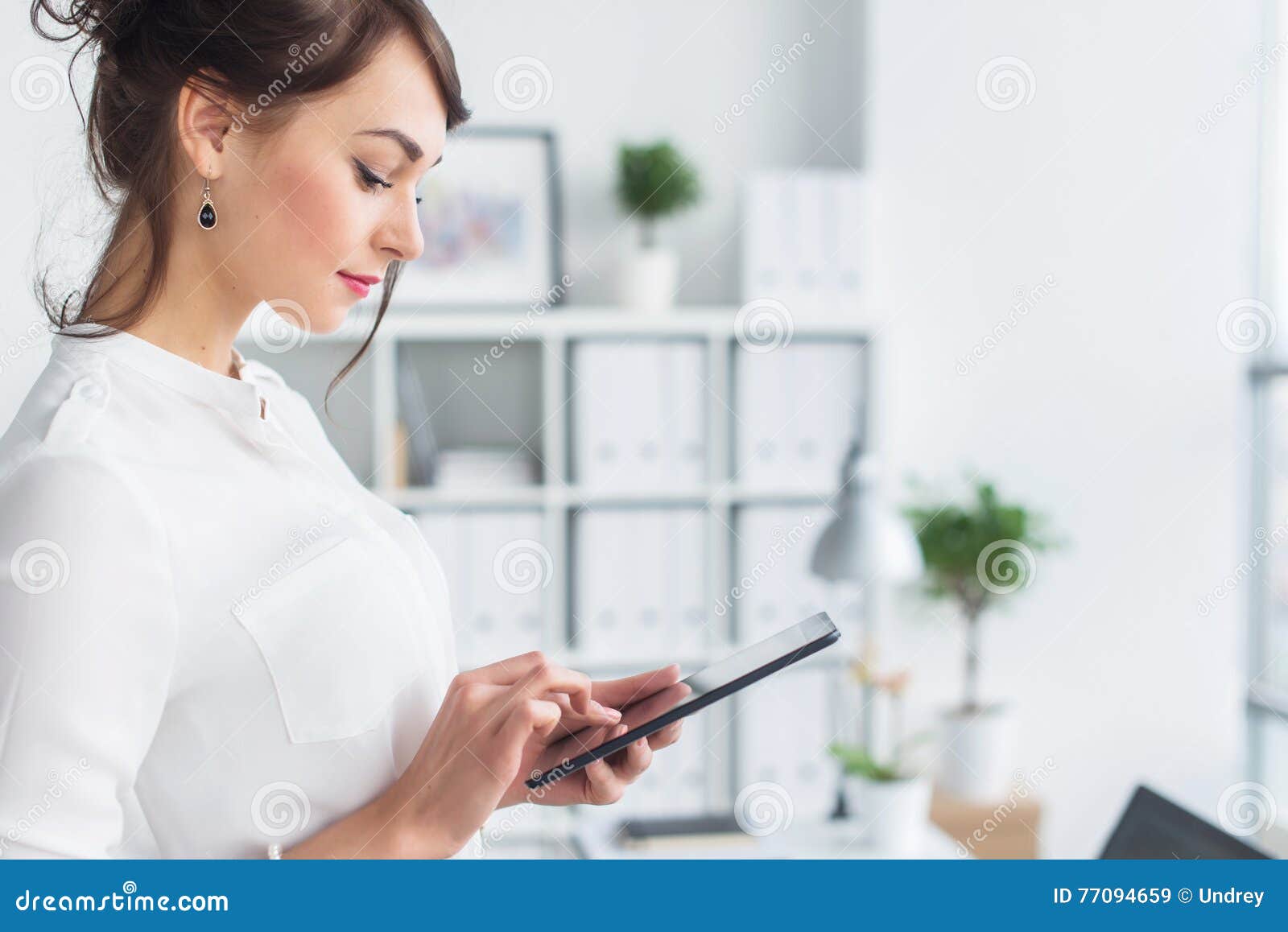 Portrait of an Office Manager Holding Her Tablet, Typing, Using Wi-fi ...