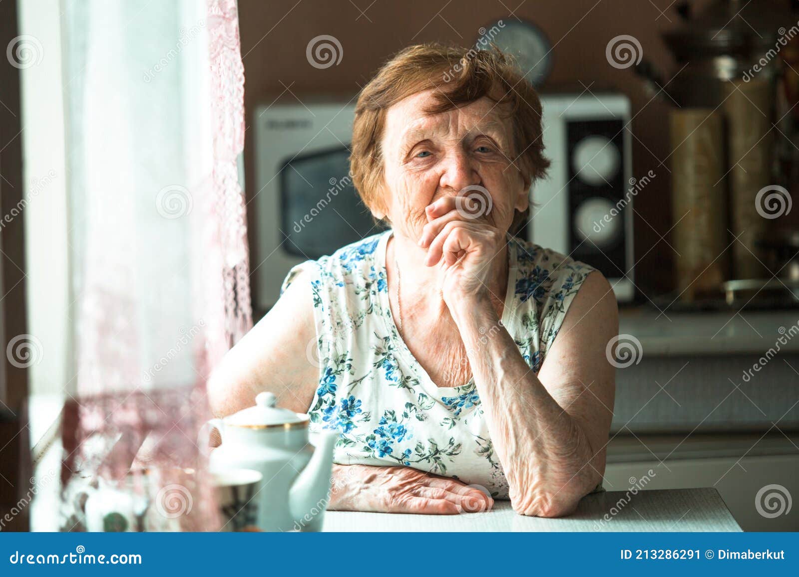 Portrait of an Old Retired Woman Sitting at a Table. Stock Image ...