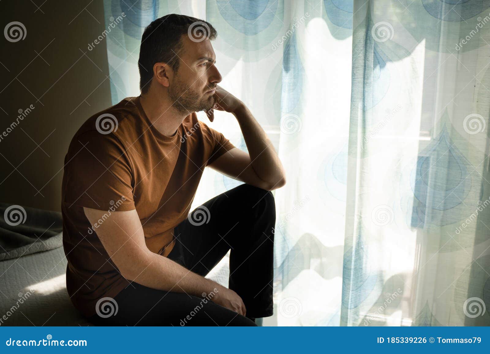 Portrait of One Guy Feeling Sad and Looking through Window Stock Photo ...