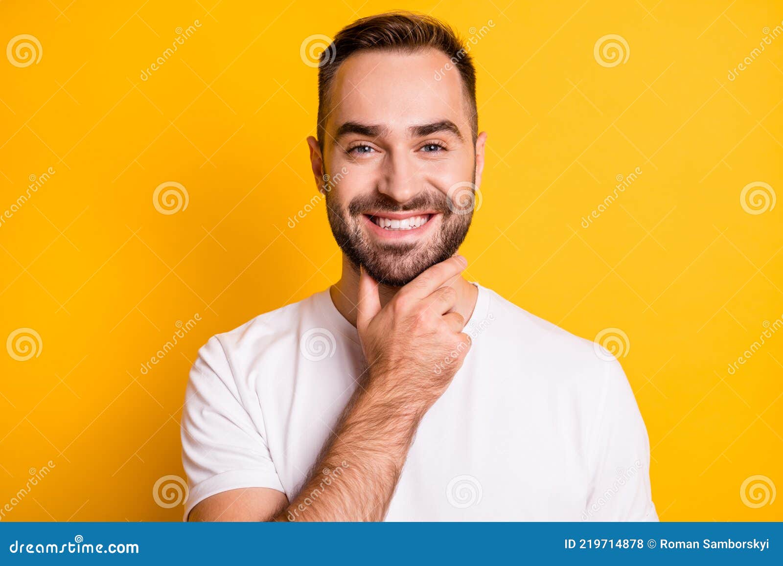 Portrait Of Optimistic Guy Hand Chin Wear White T Shirt Isolated On