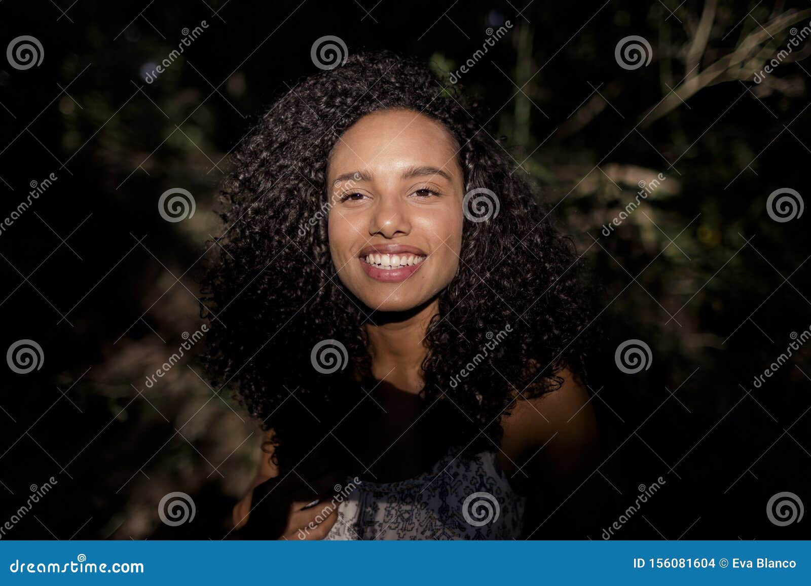Portrait Outdoors Of A Beautiful Young Afro American Woman Smiling At