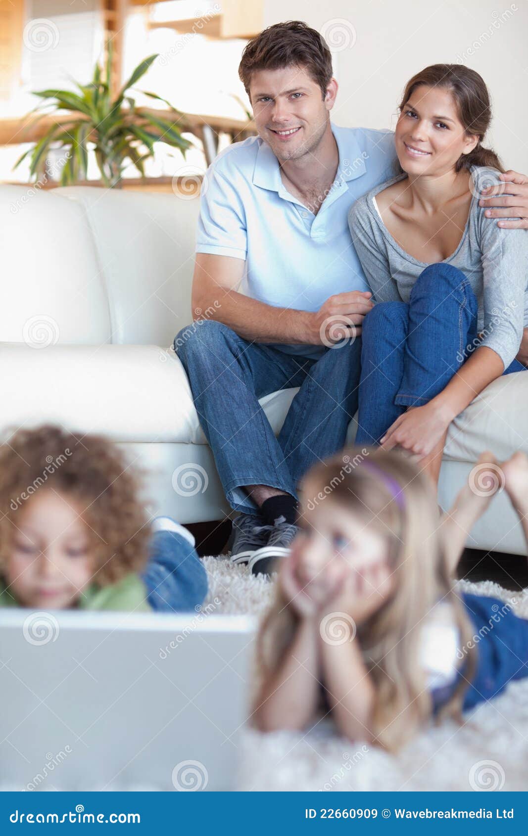 Portrait of Parents Watching Their Children Using a Laptop Stock Image ...
