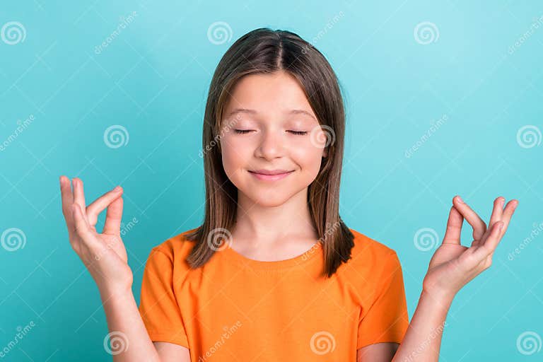 Portrait Of Peaceful Schoolgirl With Straight Hairdo Dressed Orange T