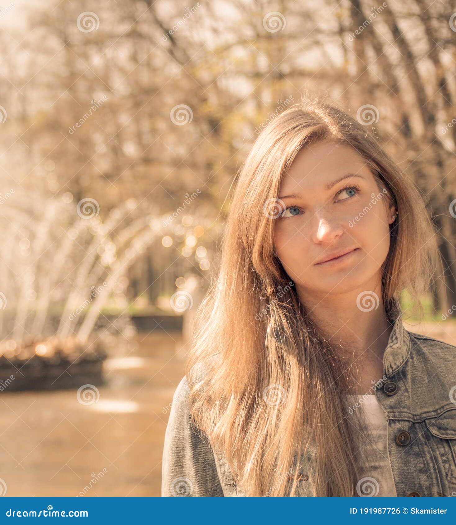 Portrait Of Pensive Attractive Blonde Woman With Long Hair In Gold