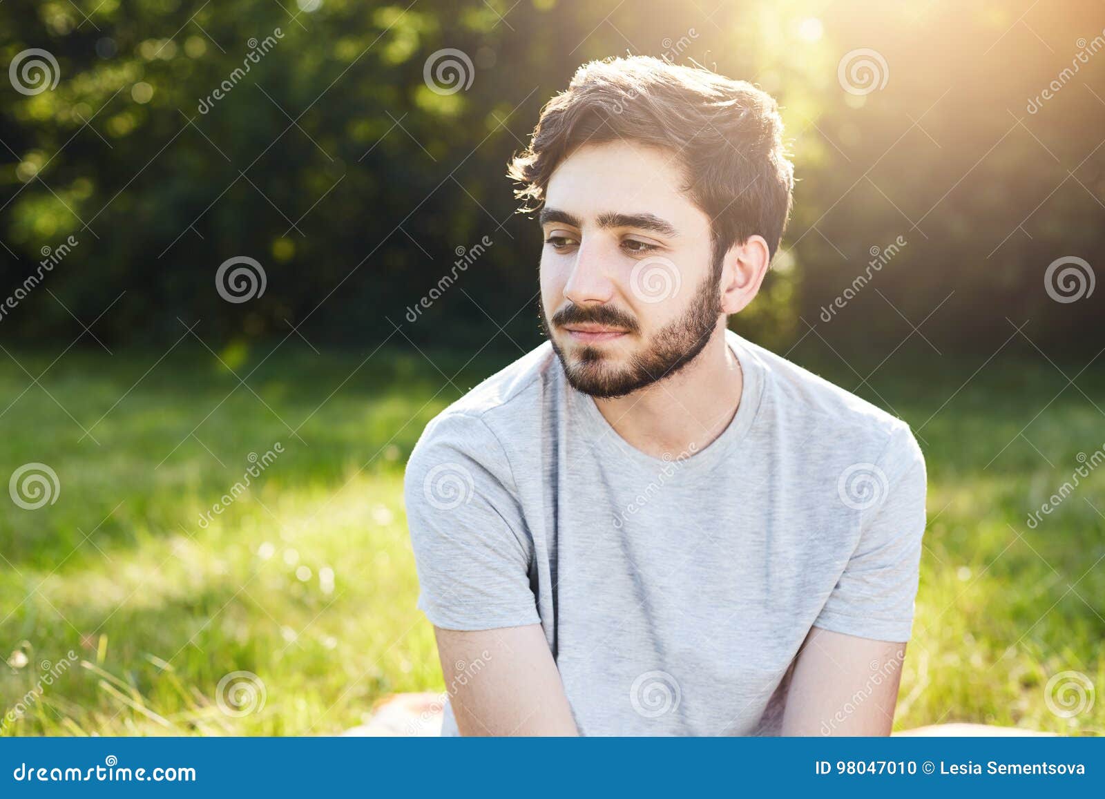 Portrait Of Pensive Bearded Male With Stylish Hairdo Looking Down With