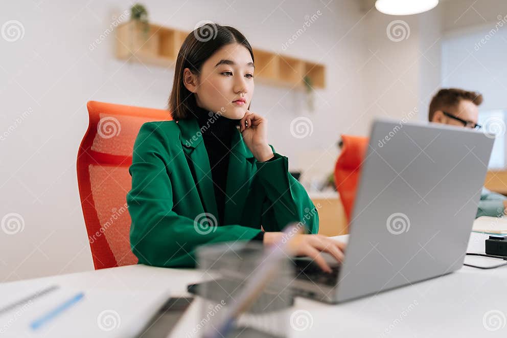 Portrait of Pensive Female Programmer Typing Program Code on Laptop ...
