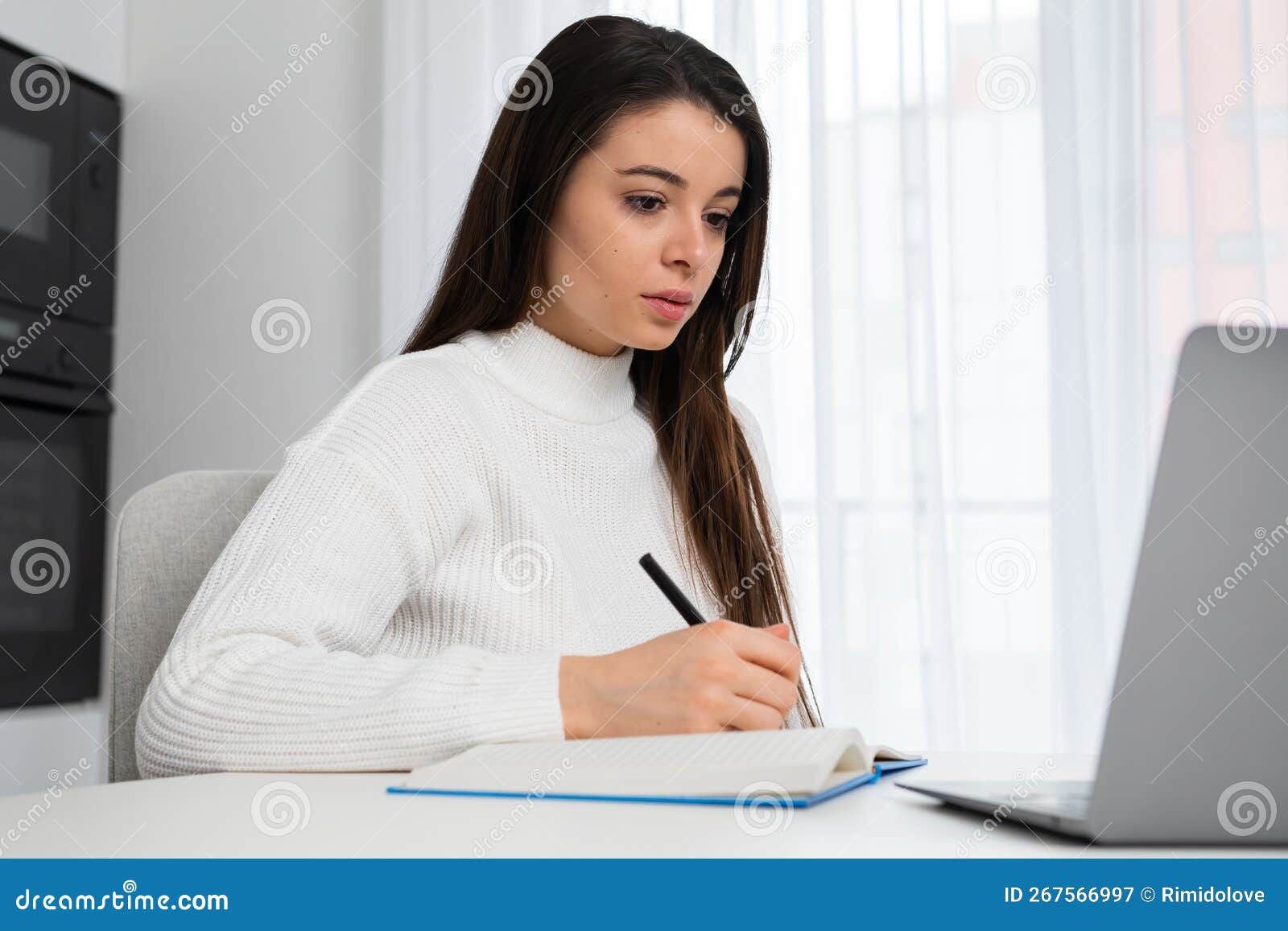 Portrait of a Pensive Young Student Making Notes To the Textbook during ...
