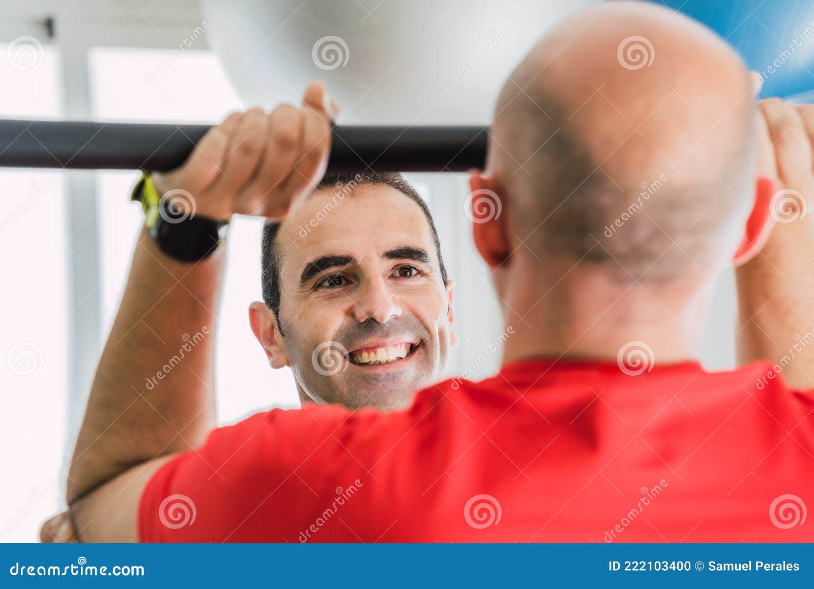 Personal Trainer Smiling in Front of a Client Stock Photo - Image of ...