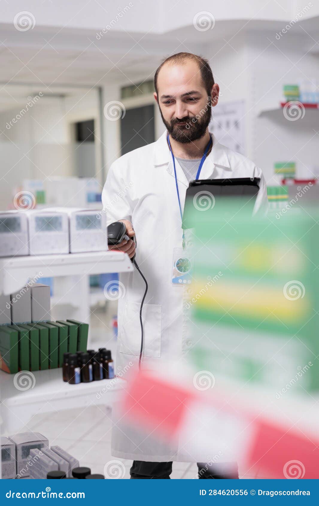 Portrait of Pharmacist Checking Medication List on Tablet Computer ...