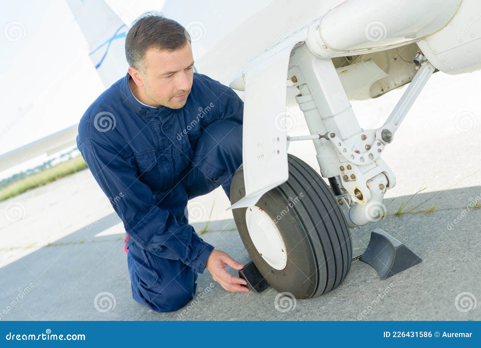 Portrait Plane Mechanic Changing Wheel Stock Photo - Image of pilot ...