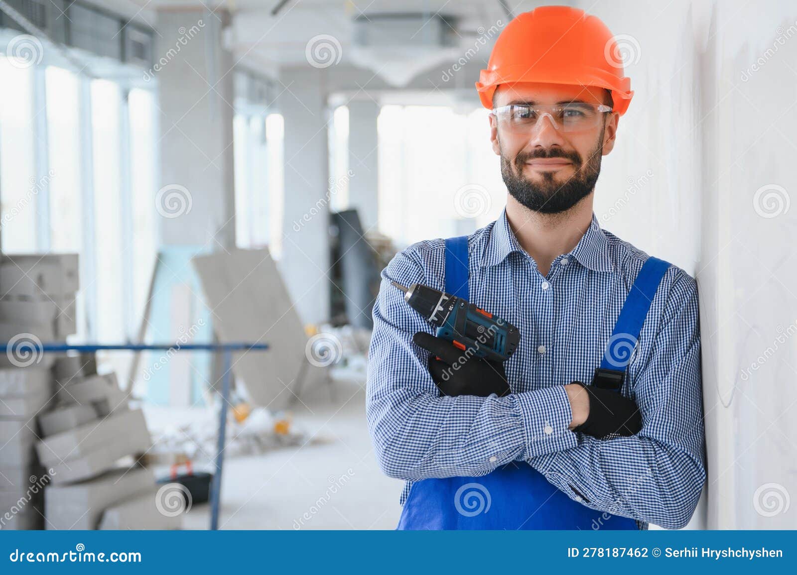 Portrait of Positive, Handsome Young Male Builder in Hard Hat while ...