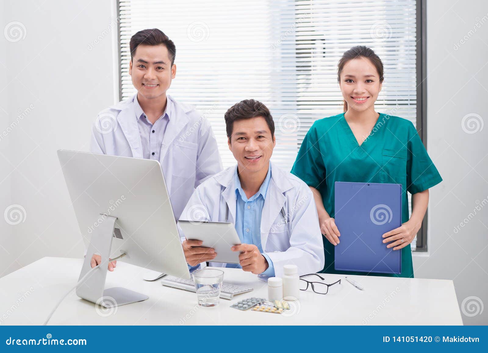 Portrait of Positive Medical Professionals on Office and Looking at ...