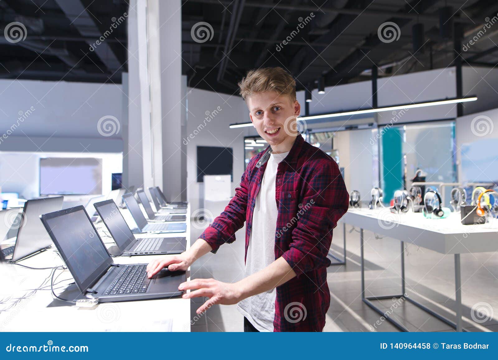 Portrait of a Positive Young Man in the Electronics Store while ...