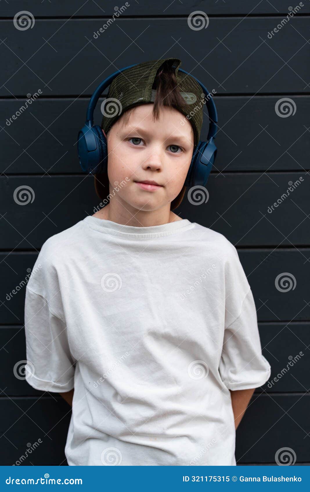 Portrait of a Pre-teen Boy in a Cap with Headphones Wearing a White T ... Portrait of a Pre-teen Boy in a Cap with Headphones Wearing a White T ...
