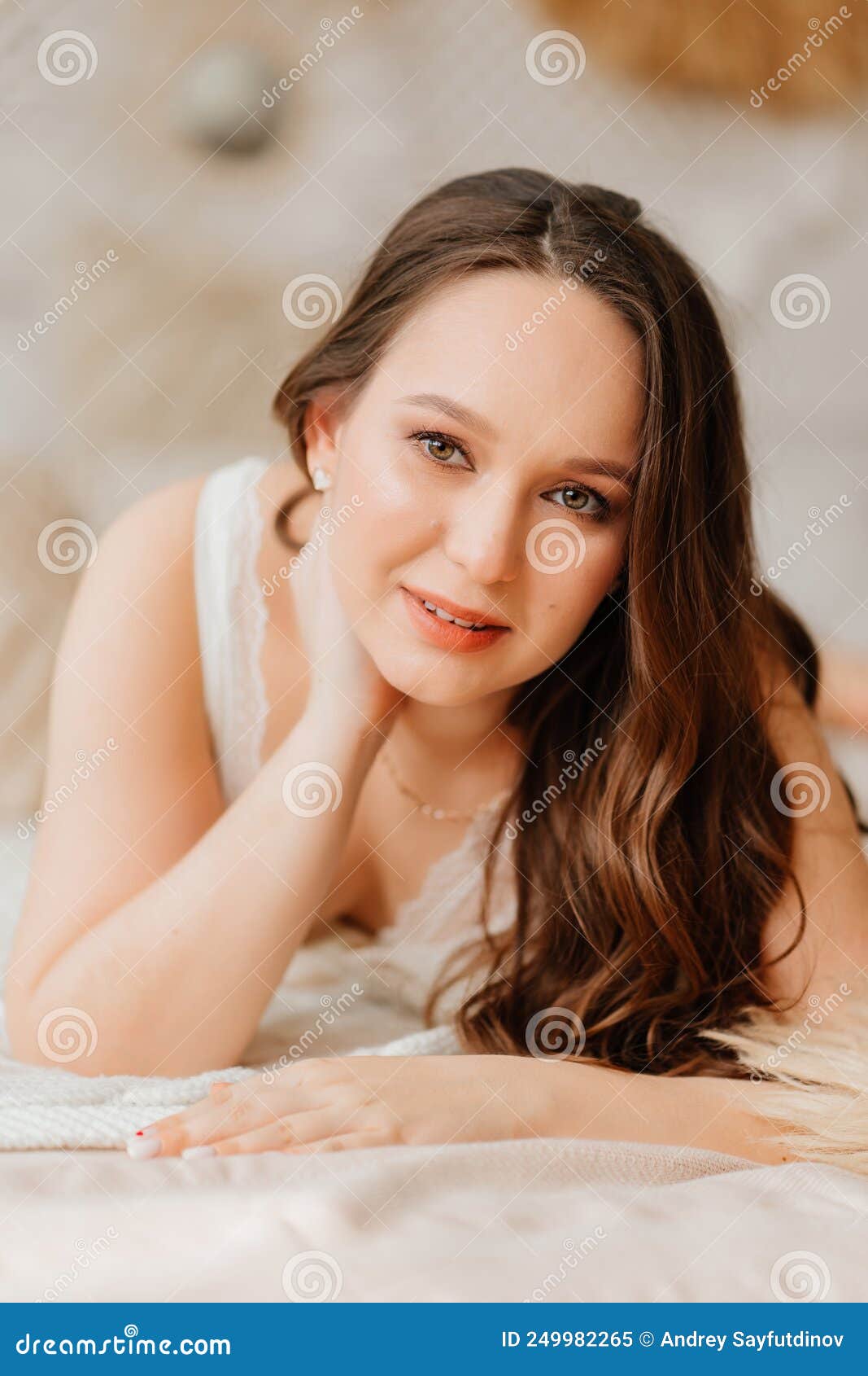 Portrait Of A Pregnant Woman In White Peignoir In Bed Clothes Stock