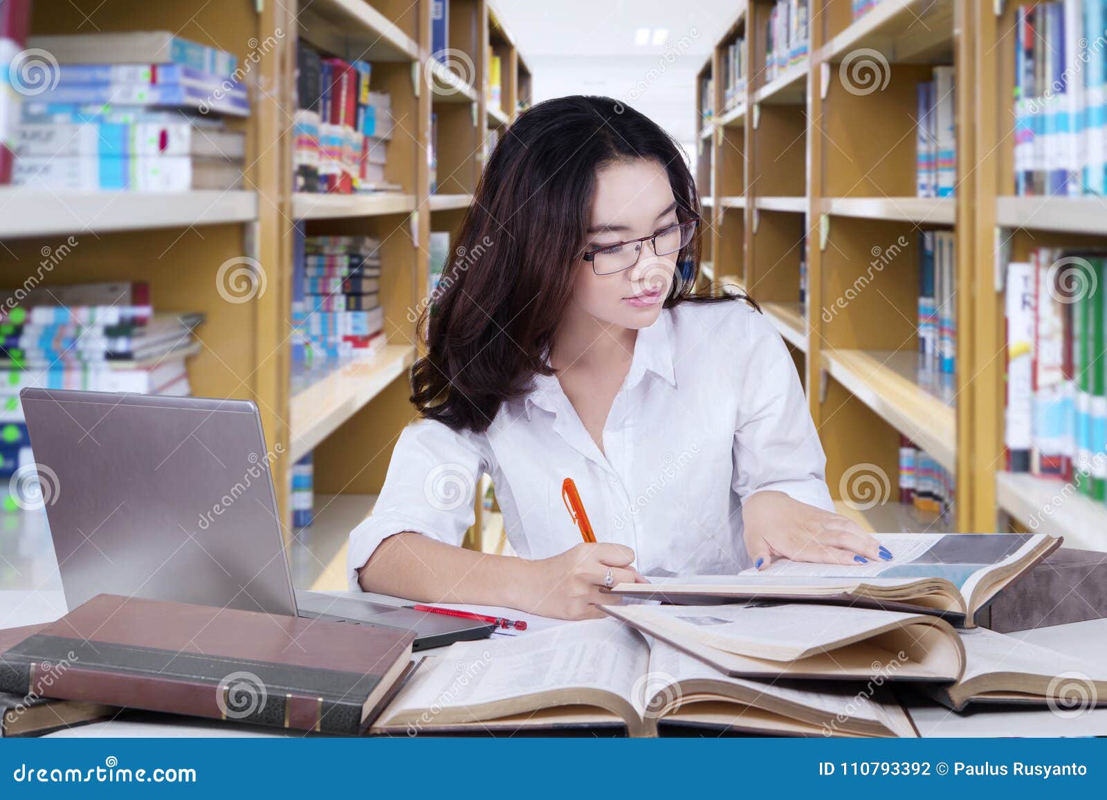 Pretty Female Student Doing Schoolwork in Library Stock Photo - Image ...