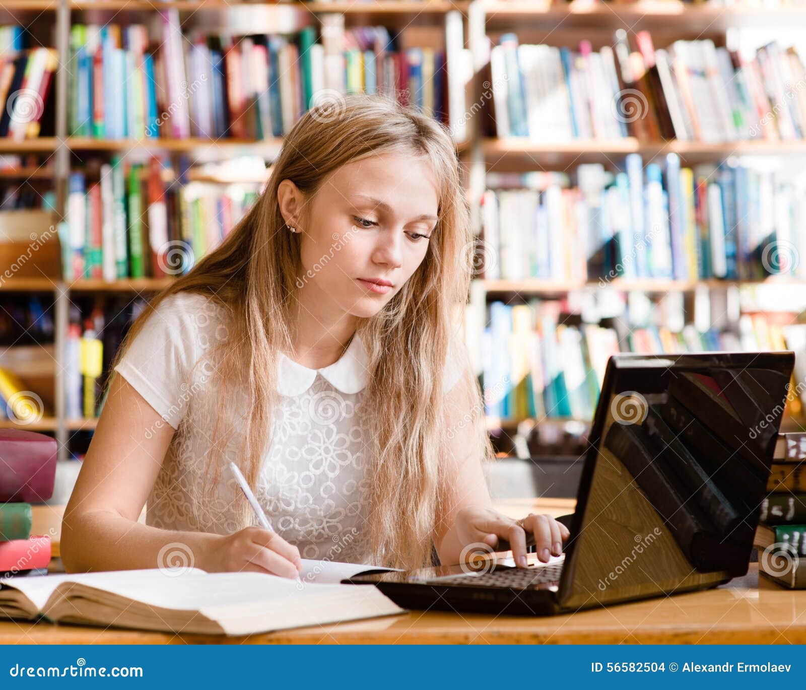 Portrait of a Pretty Female Student with Laptop in Library Stock Photo ...