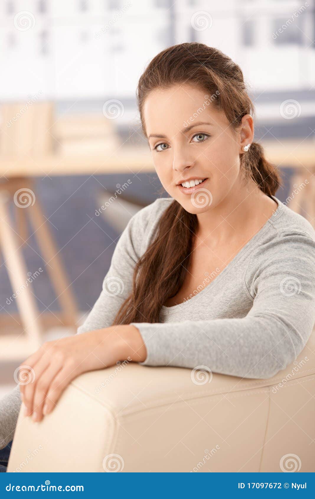 Portrait of Pretty Girl Sitting on Sofa Smiling Stock Photo - Image of ...