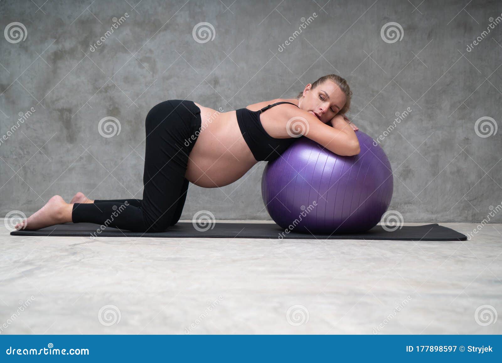 Portrait Of Pretty Pregnant Woman Exercises With Fitball In The Gym