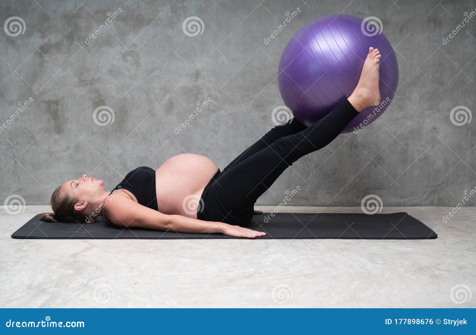 Portrait Of Pretty Pregnant Woman Exercises With Fitball In The Gym