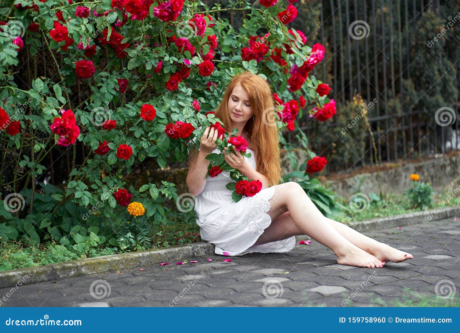 Portrait Of A Pretty Redhead Girl Dressed In A White Light Dress On A